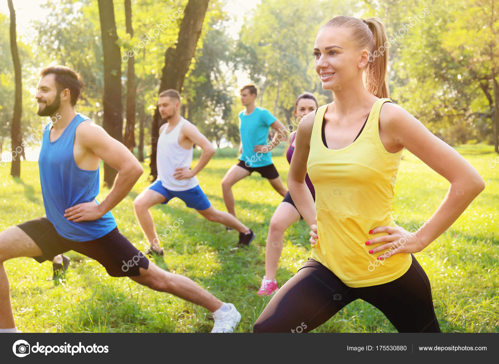 Group of young people training in park Stock Photo by ©belchonock 175530880