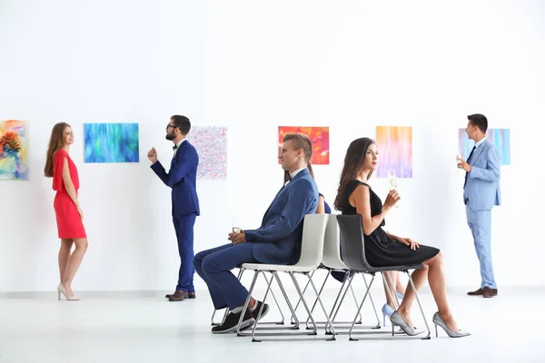 Group of people in formal wear at art gallery exhibition - Stock Image ...