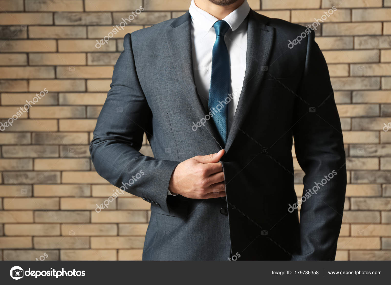 Handsome man in formal suit against brick wall, closeup Stock Photo by ...