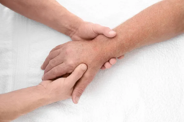 Physiotherapist giving hand massage to senior patient, closeup - Stock ...