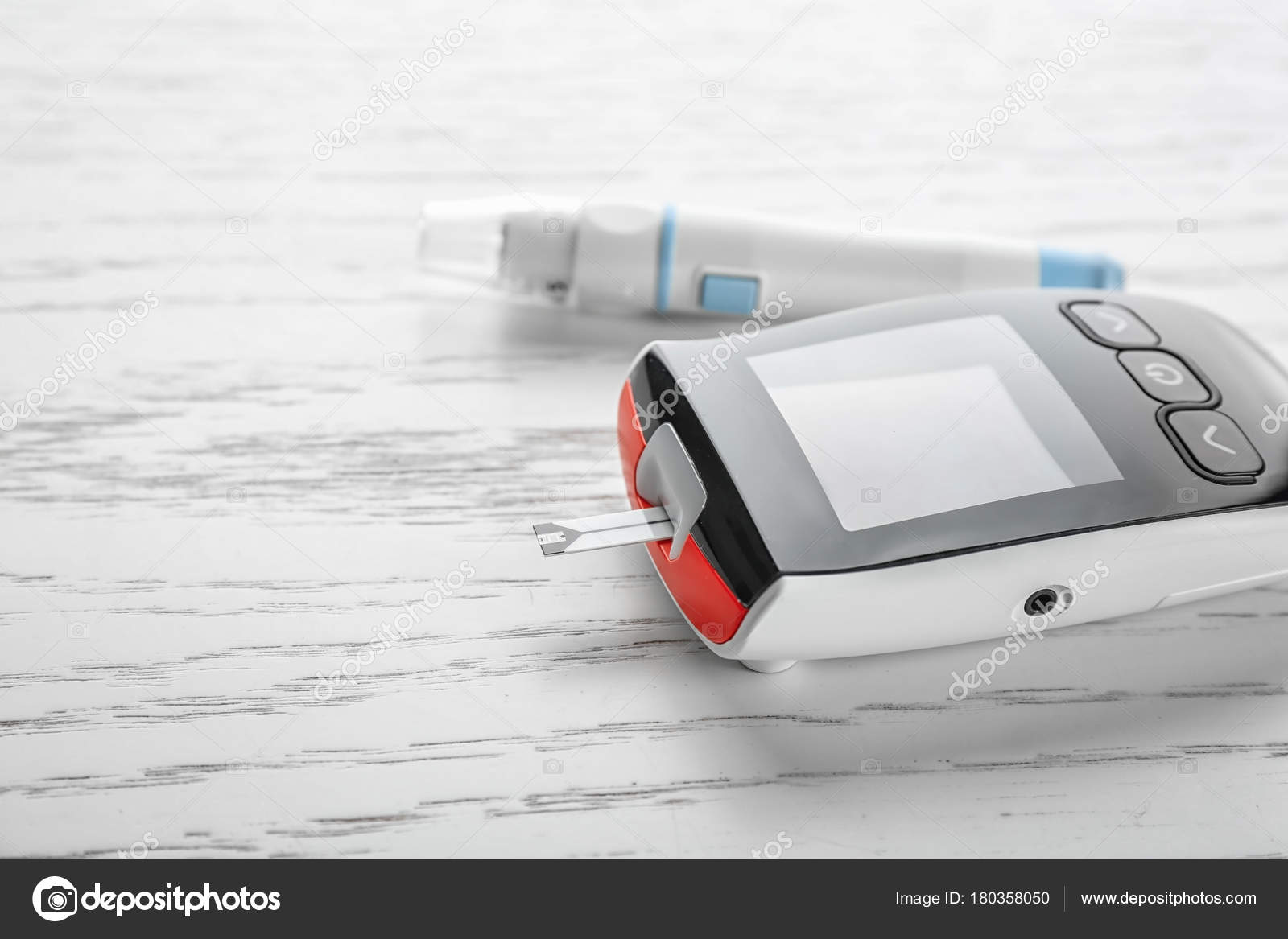 Digital glucometer and lancet pen on light background. Diabetes ...