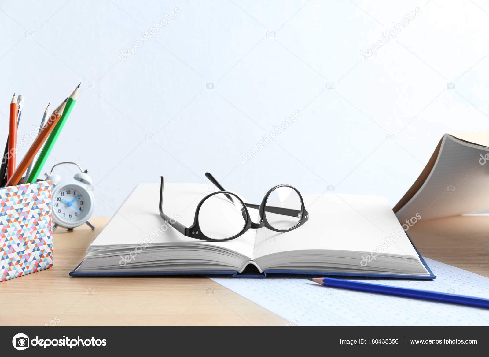 Open notebook with students eyeglasses Stock Photo by ©belchonock 180435356