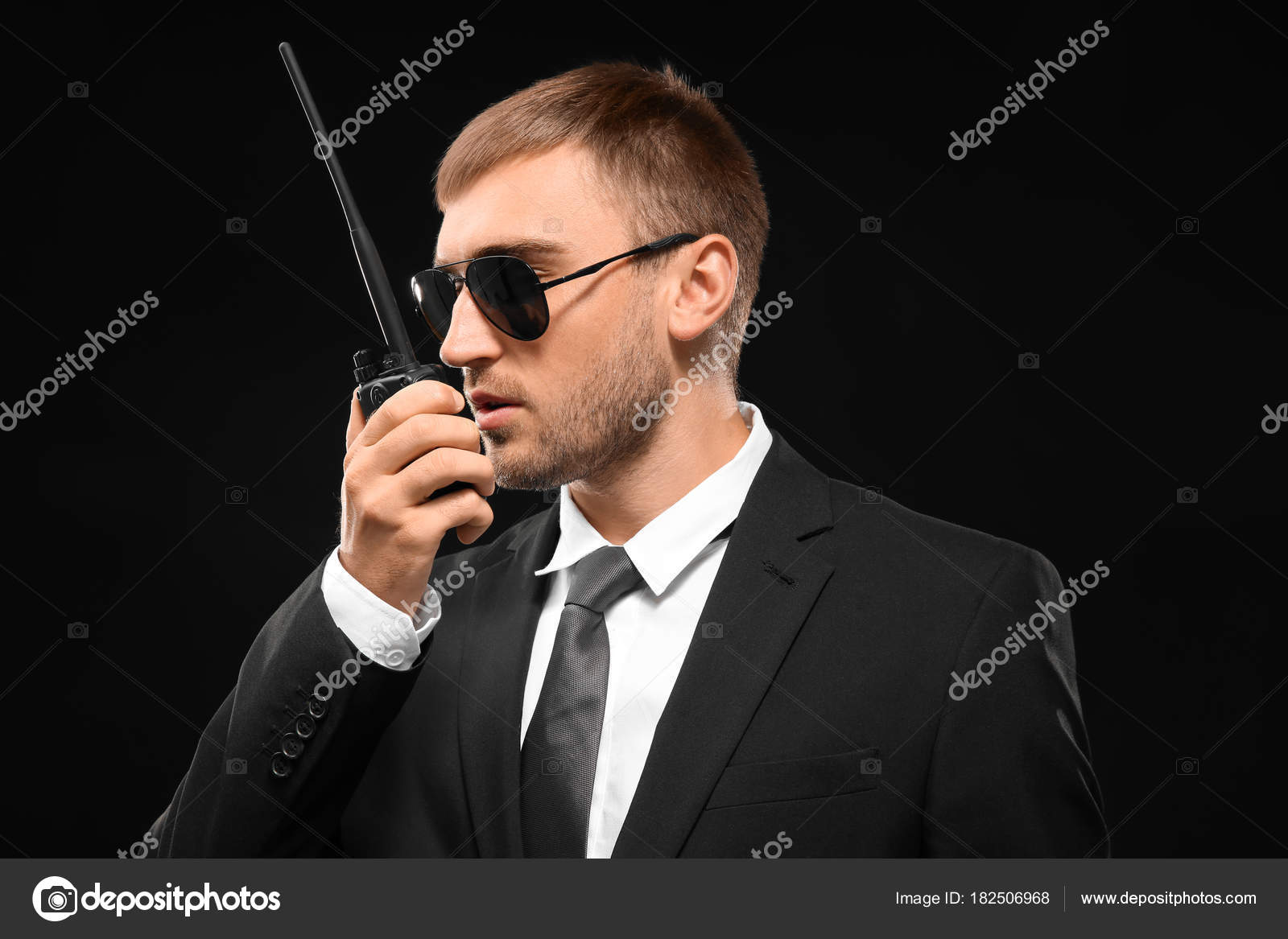 Handsome security guard on dark background Stock Photo by ©belchonock ...