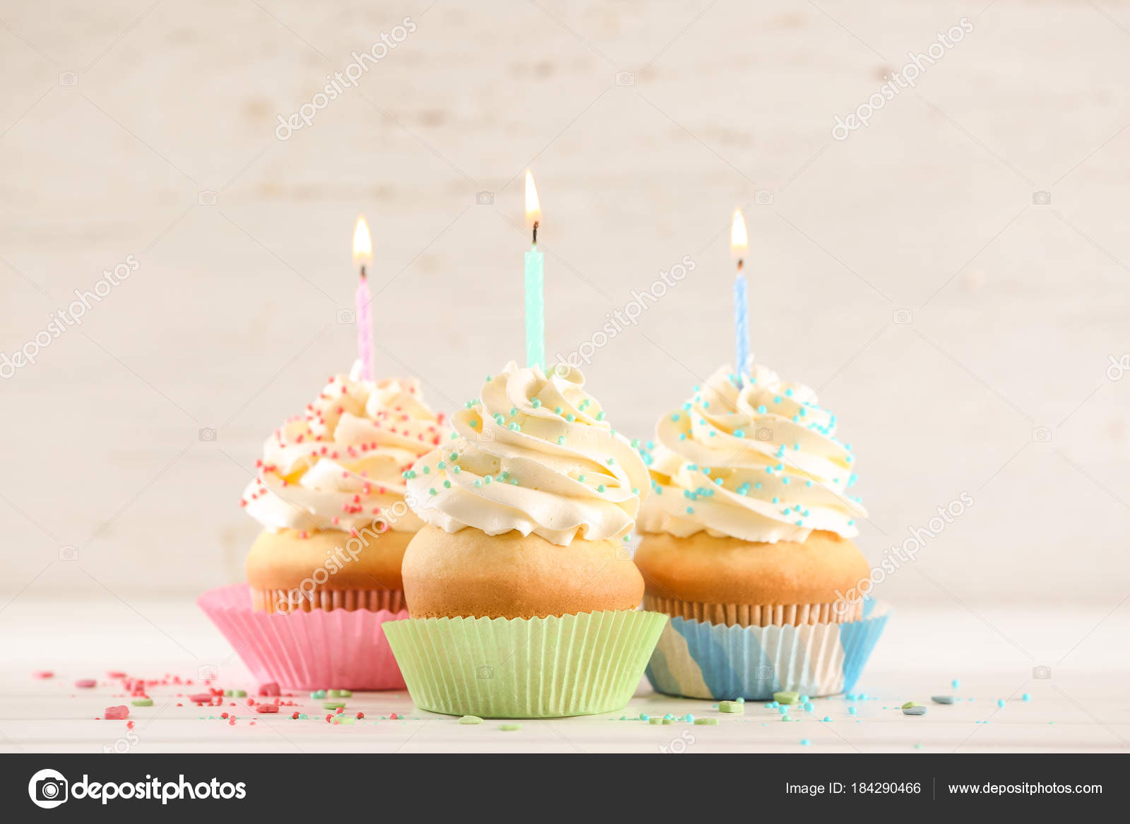 Birthday cupcakes with candles Stock Photo by ©belchonock 184290466