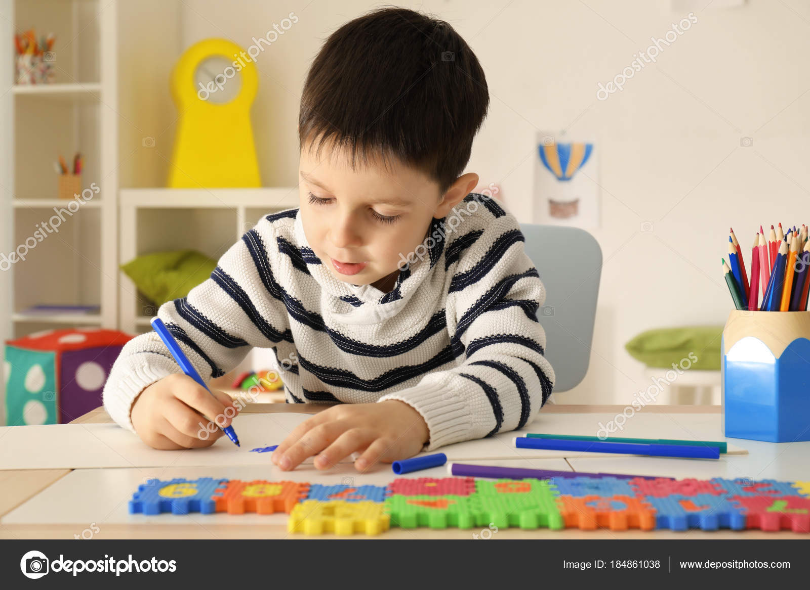 Little boy doing homework Stock Photo by ©belchonock 184861038