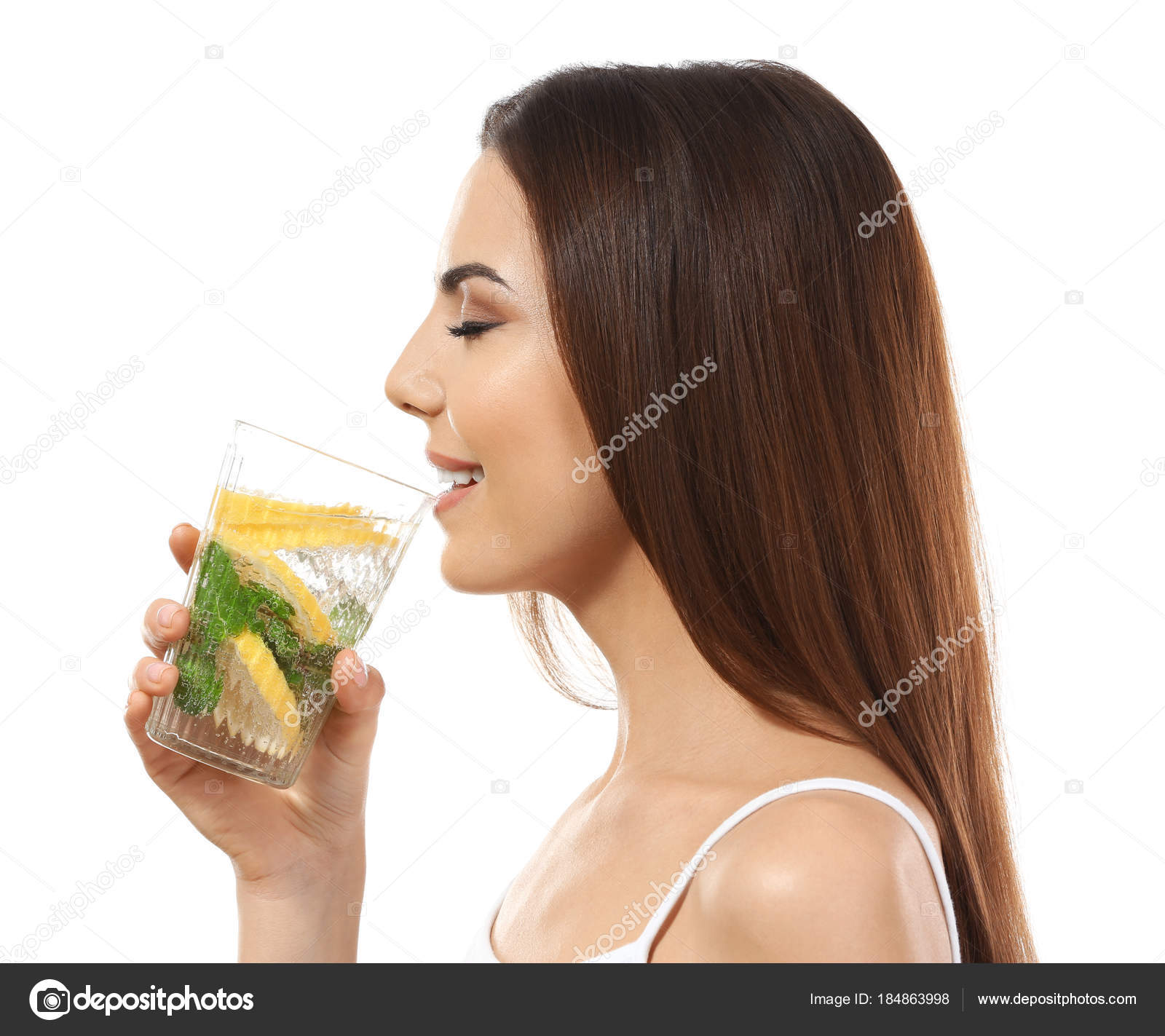 Beautiful young woman drinking lemonade on white background Stock Photo ...