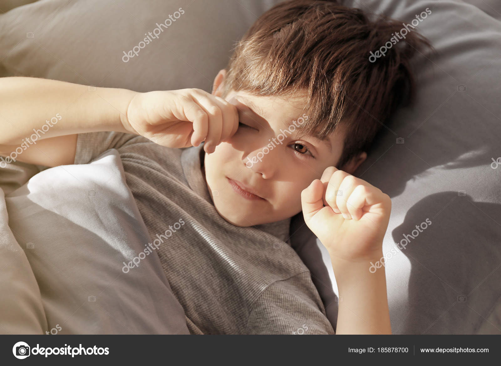Cute little boy waking up in morning at home Stock Photo by ©belchonock ...
