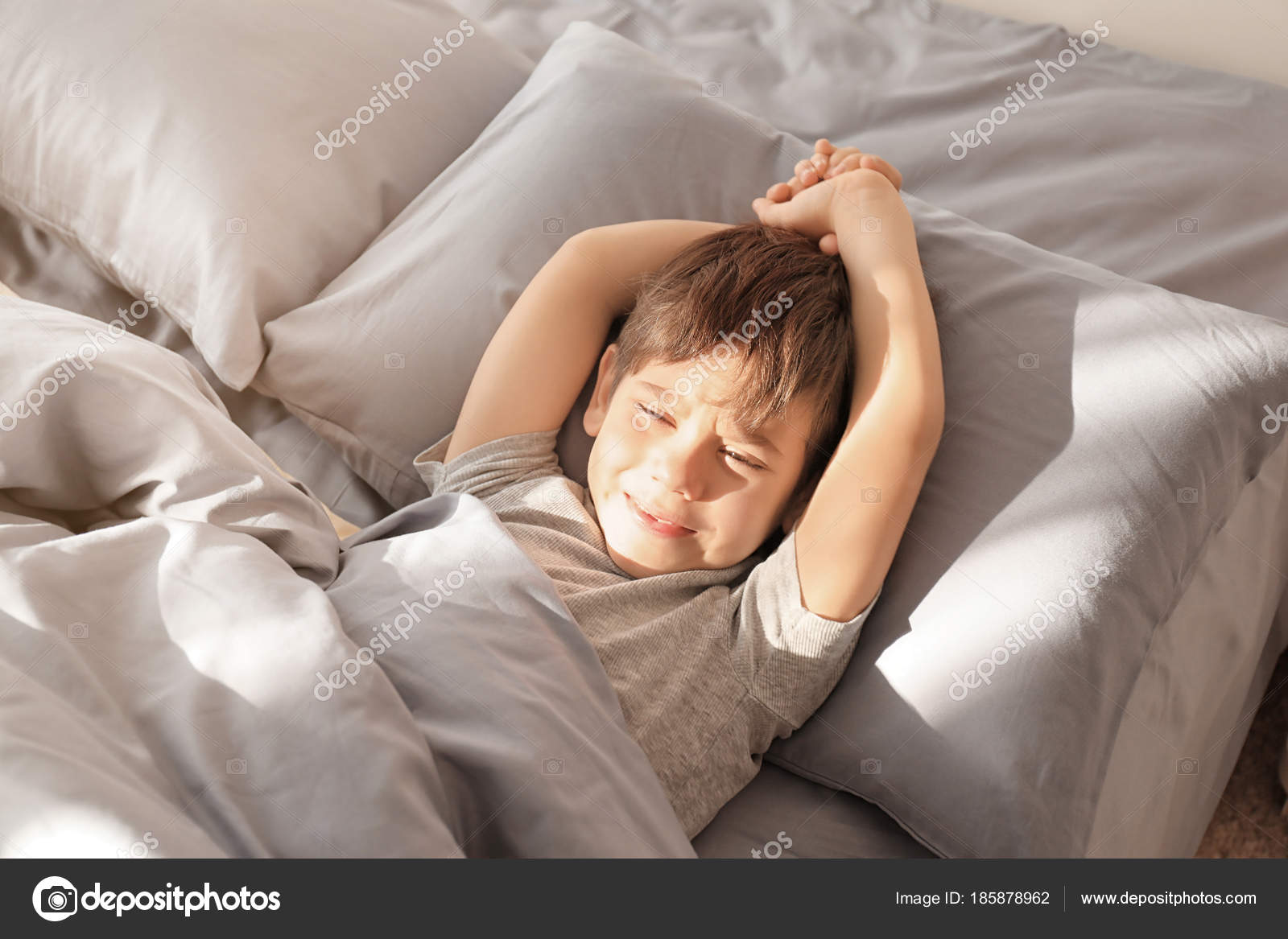 Cute little boy waking up in morning at home — Stock Photo © belchonock #185878962
