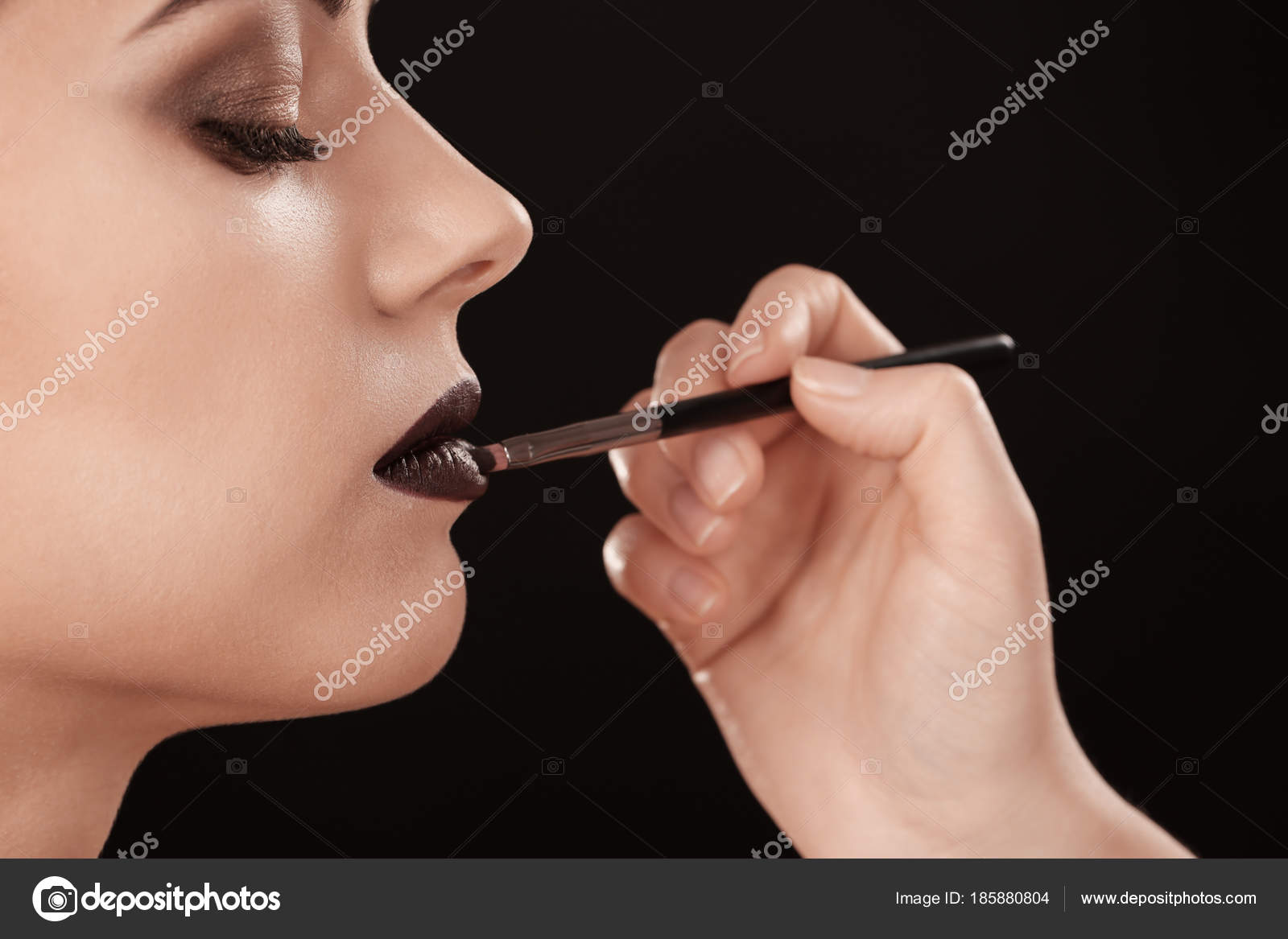 Professional visage artist applying makeup on woman's face against ...