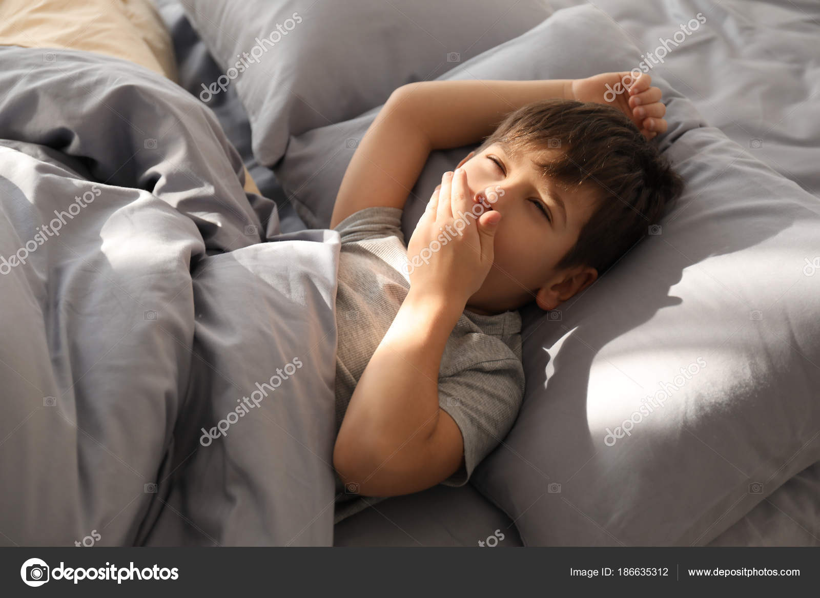 Cute little boy waking up in morning at home Stock Photo by ©belchonock ...