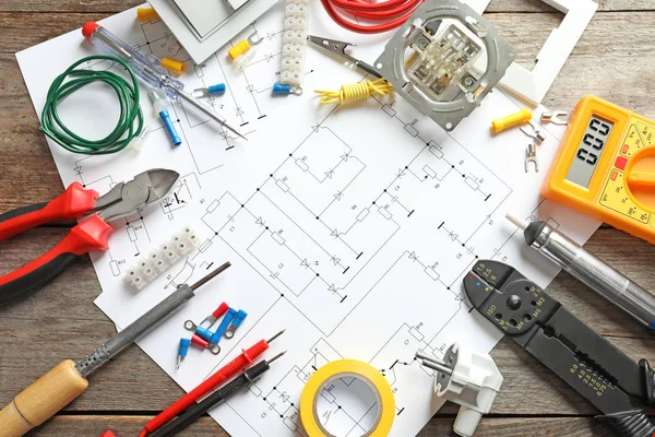 Work tools and electrical box with cables on construction drawing of ...