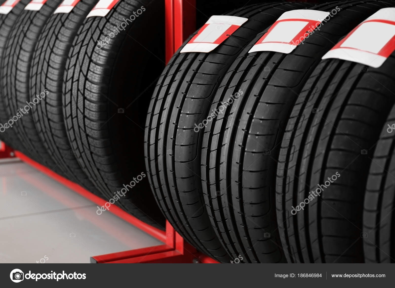 Car tires in automobile store — Stock Photo © belchonock #186846984