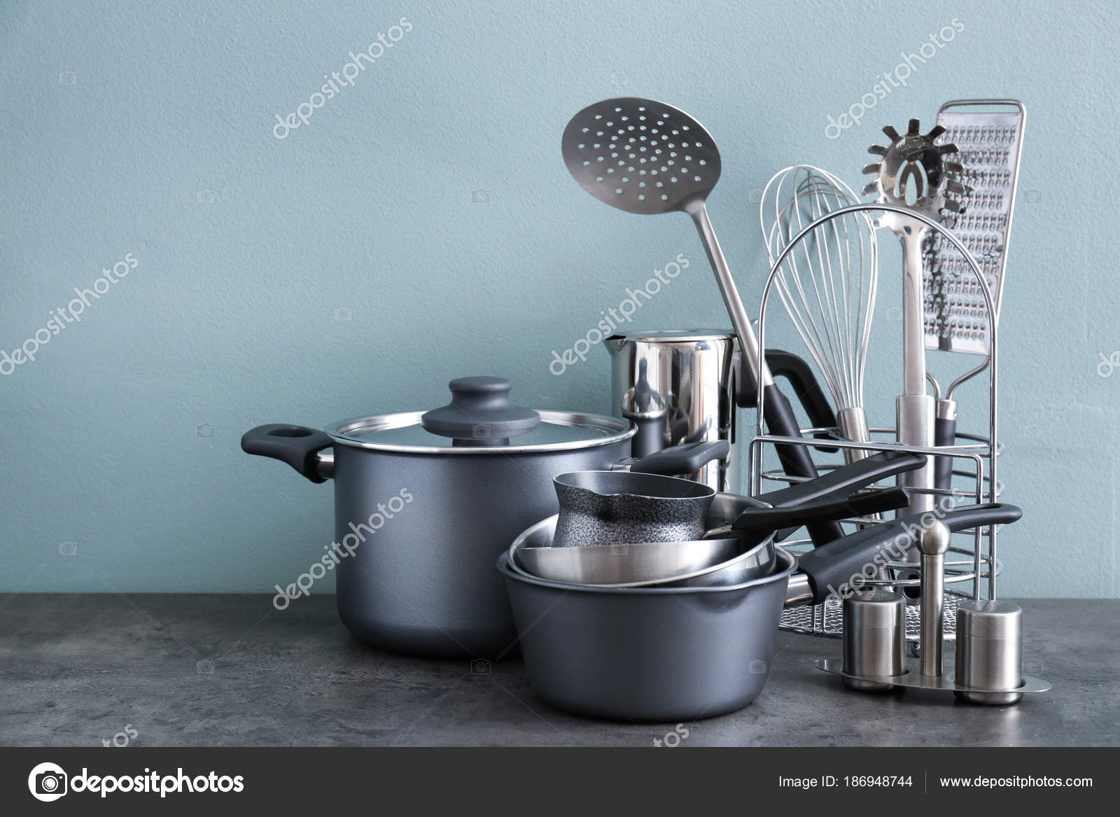 Metal cooking utensils on table Stock Photo by ©belchonock 186948744
