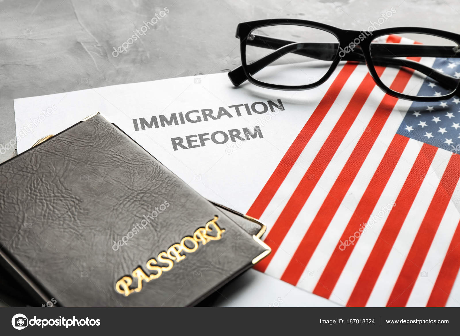 Passports, American flag and sheet of paper with words IMMIGRATION ...