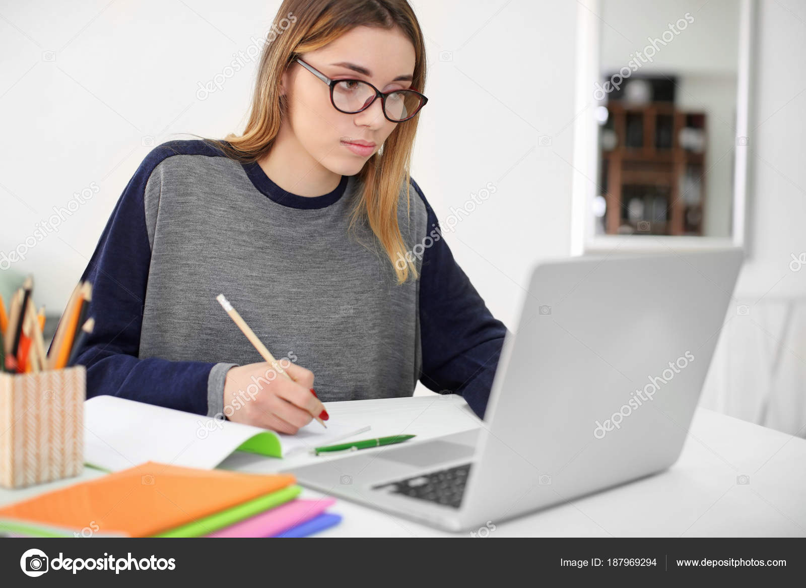 Pretty student with laptop studying at table indoors — Stock Photo ...