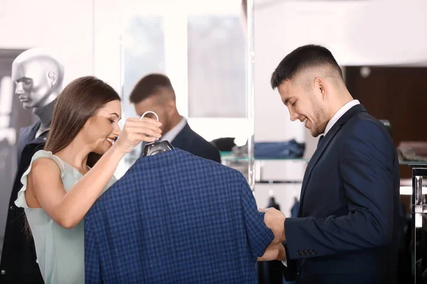 Shop Assistant Measuring Shoulders Client Figure Out Jacket Size ⬇ ...