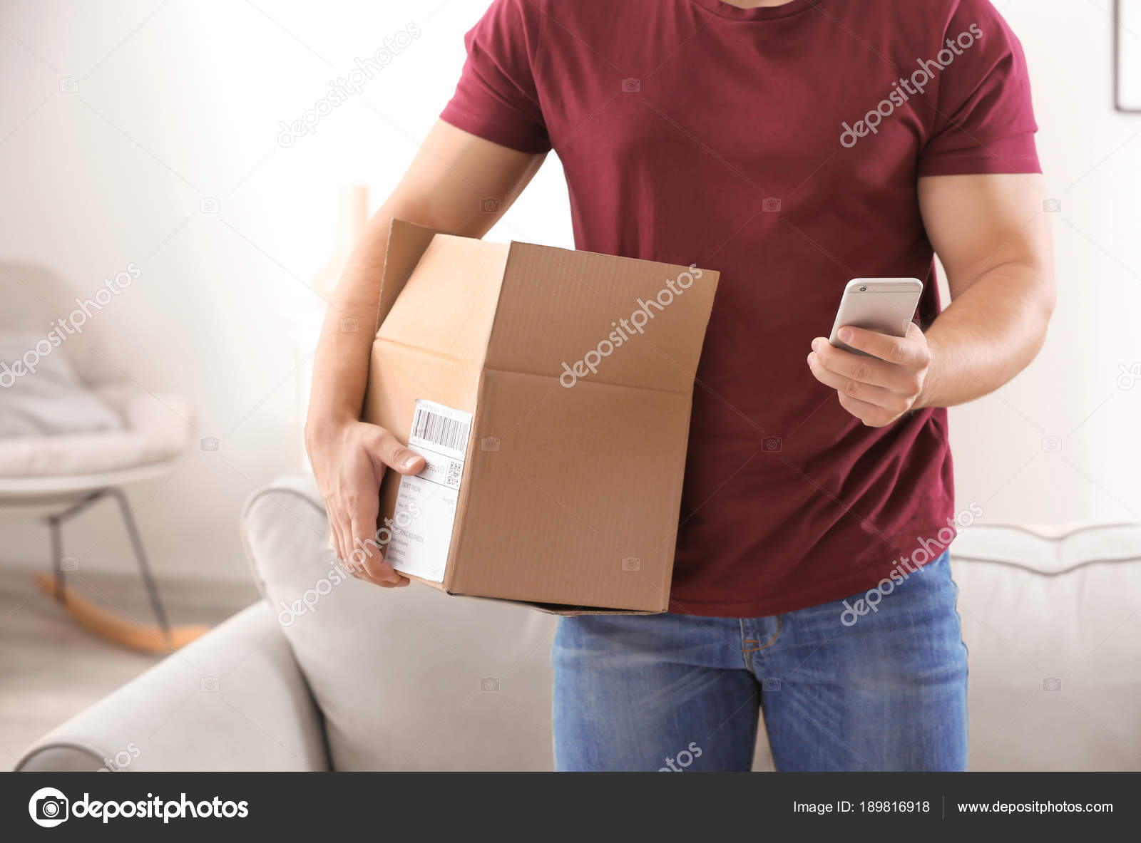 Young Man Making Call Delivered Parcel Home — Stock Photo © belchonock ...