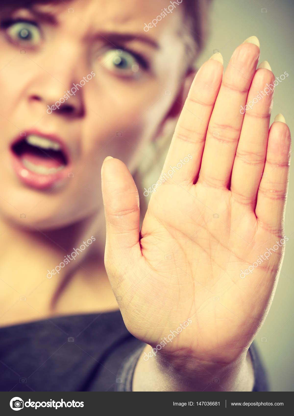 Female shows stop sign by her hand. — Stock Photo © Anetlanda #147036681