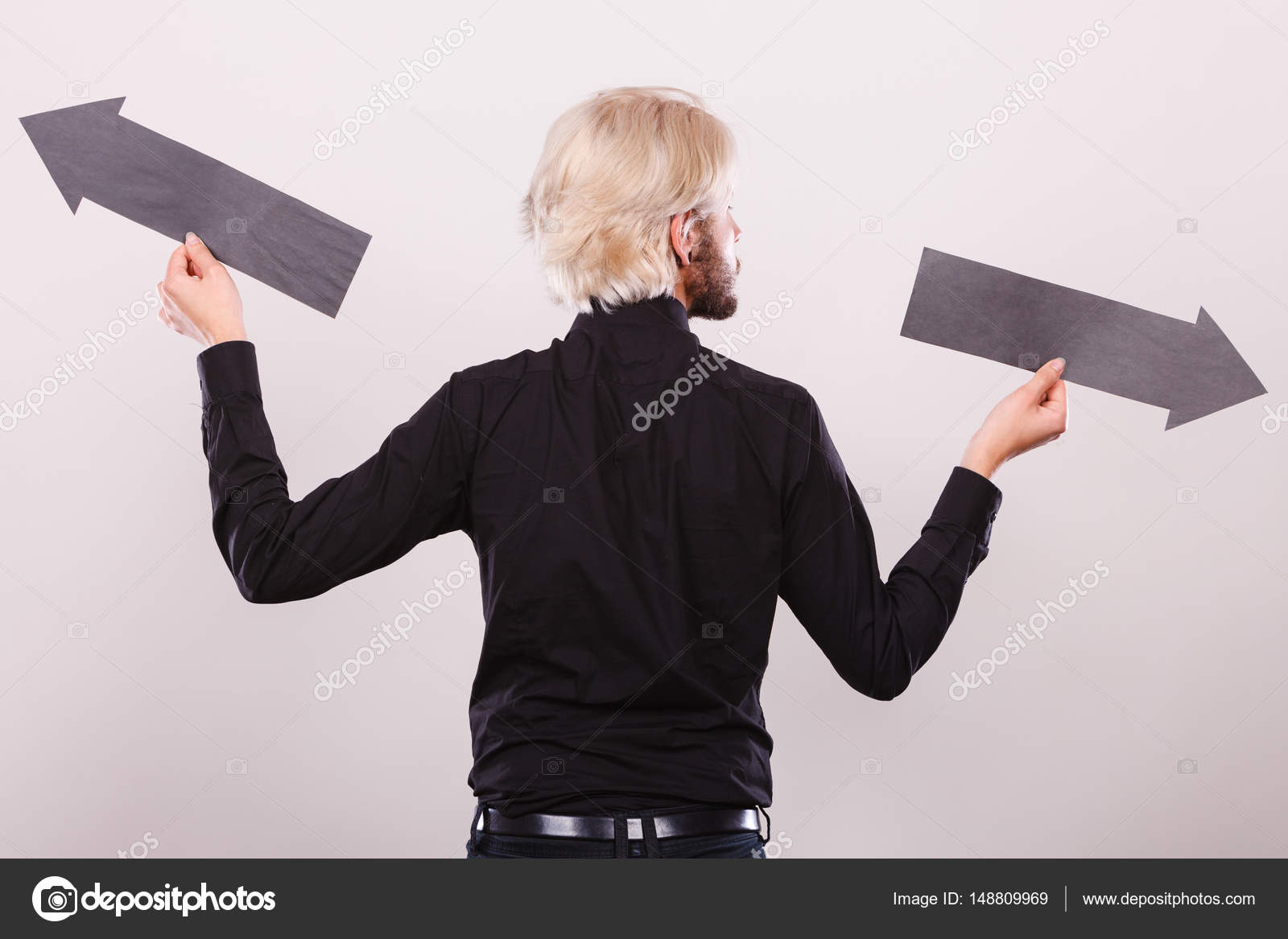Man holding black arrows pointing left and right — Stock Photo ...