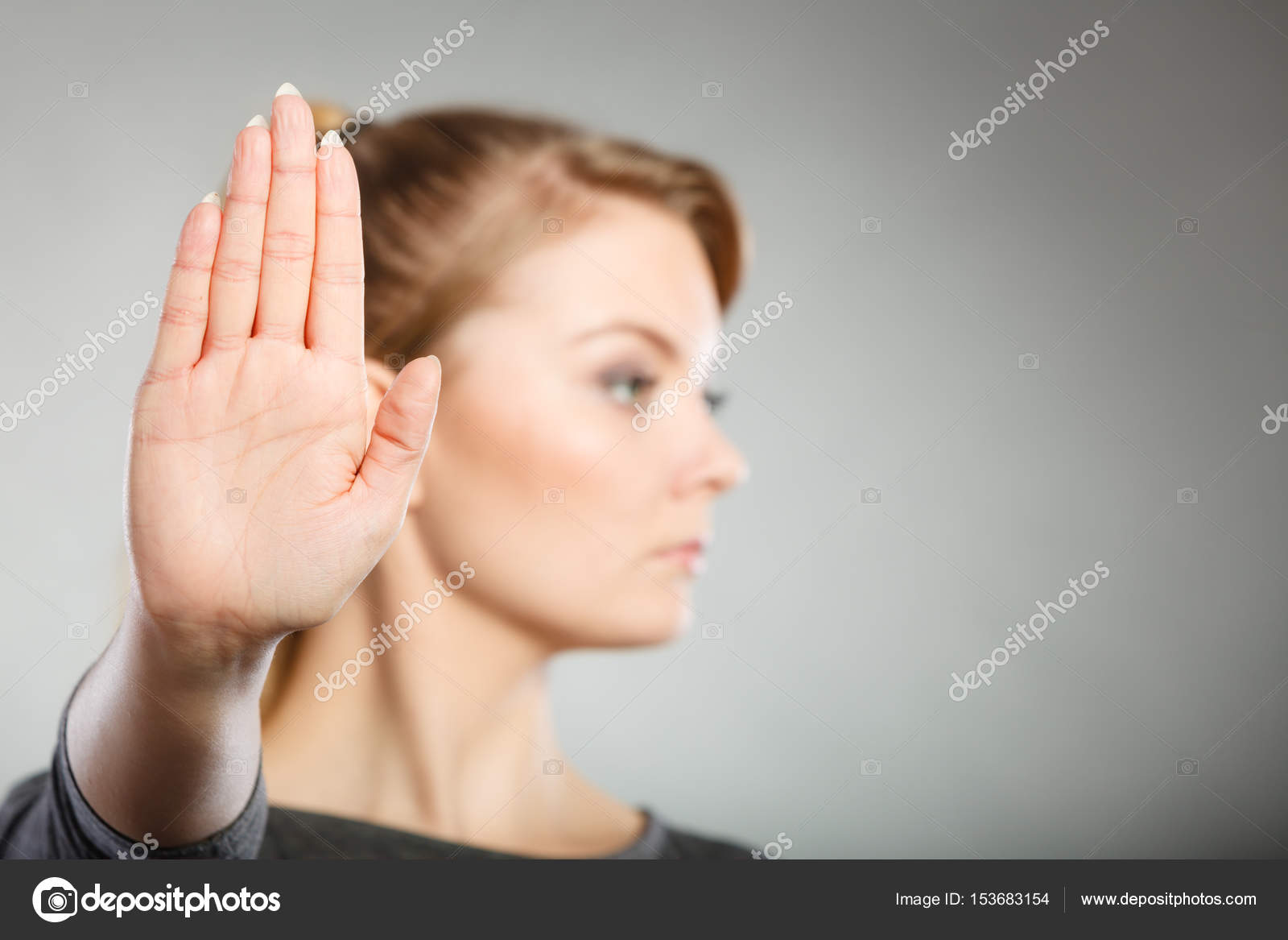 Female shows stop sign by her hand. Stock Photo by ©Anetlanda 153683154
