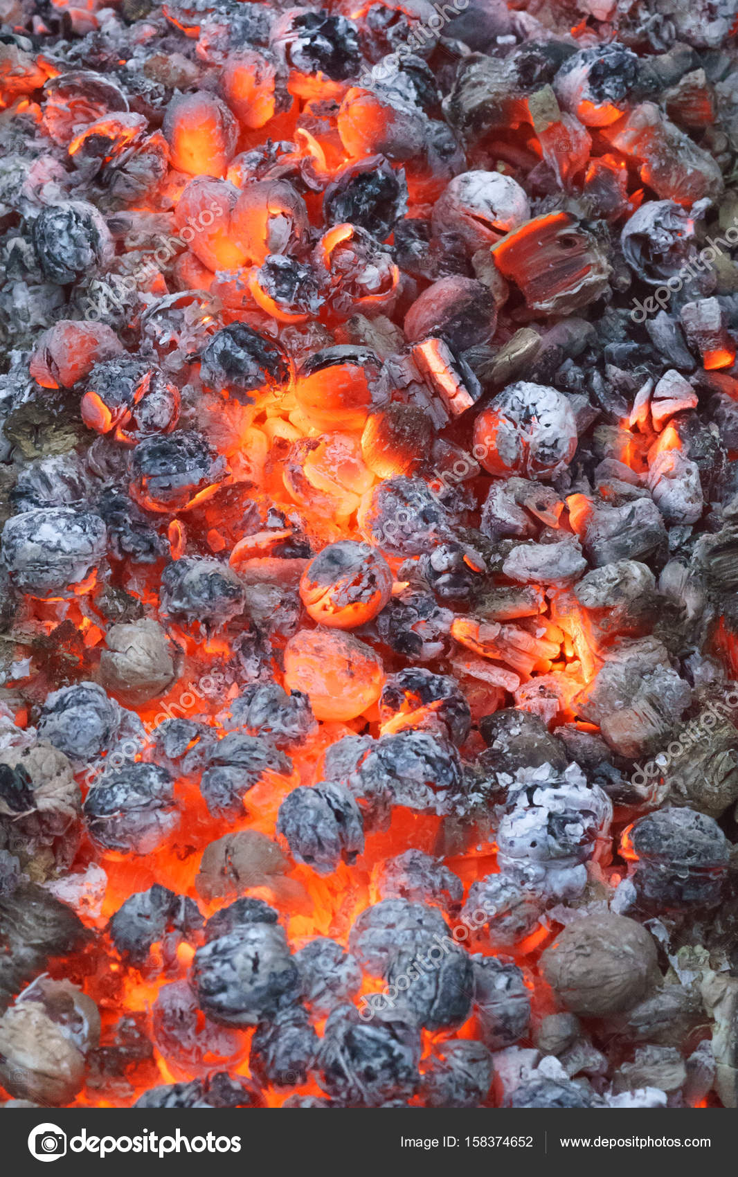 A smoldering coal fire. Bright background of black and red colors ...