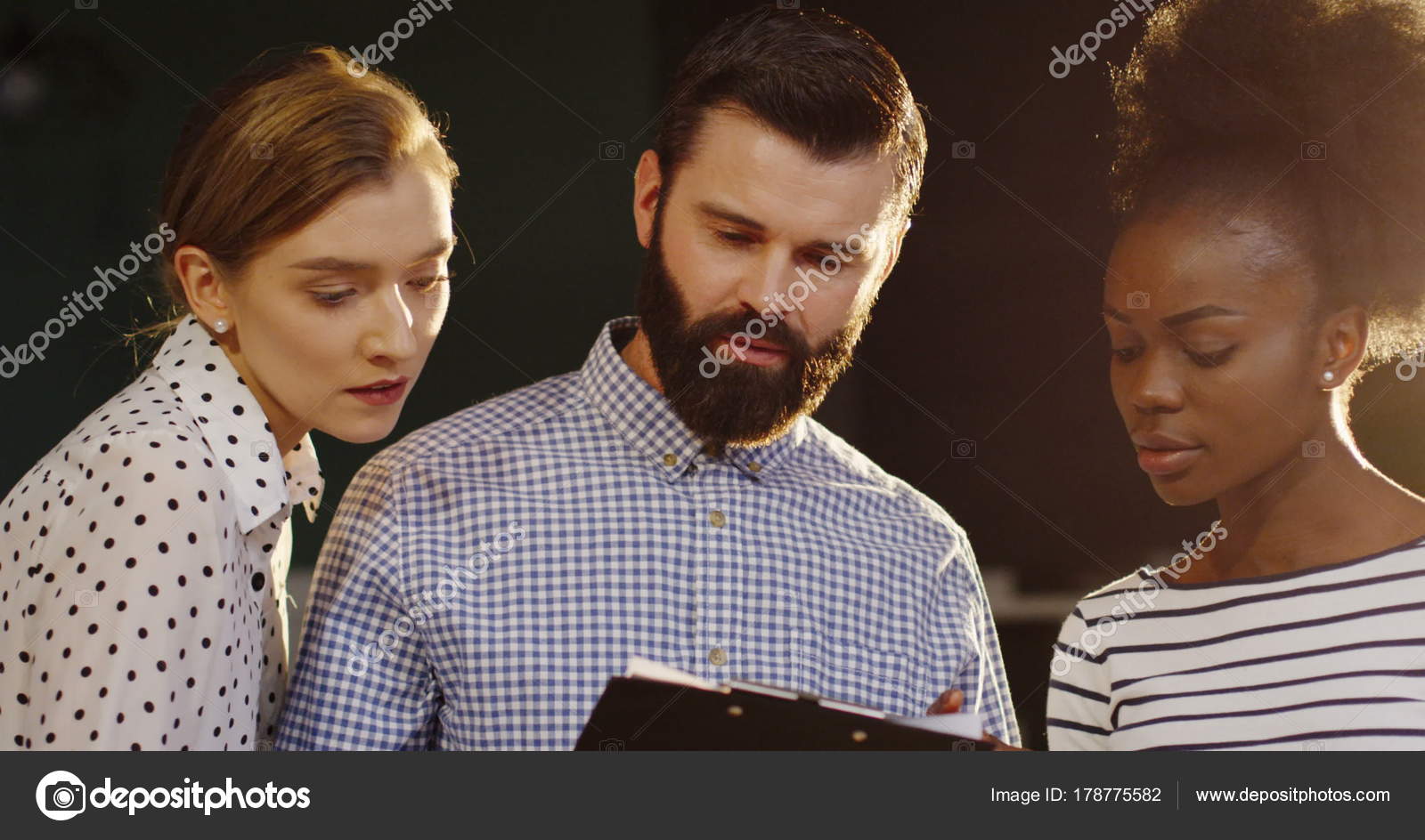 Close up of a caucasian man standing with two co-workers mixed races ...