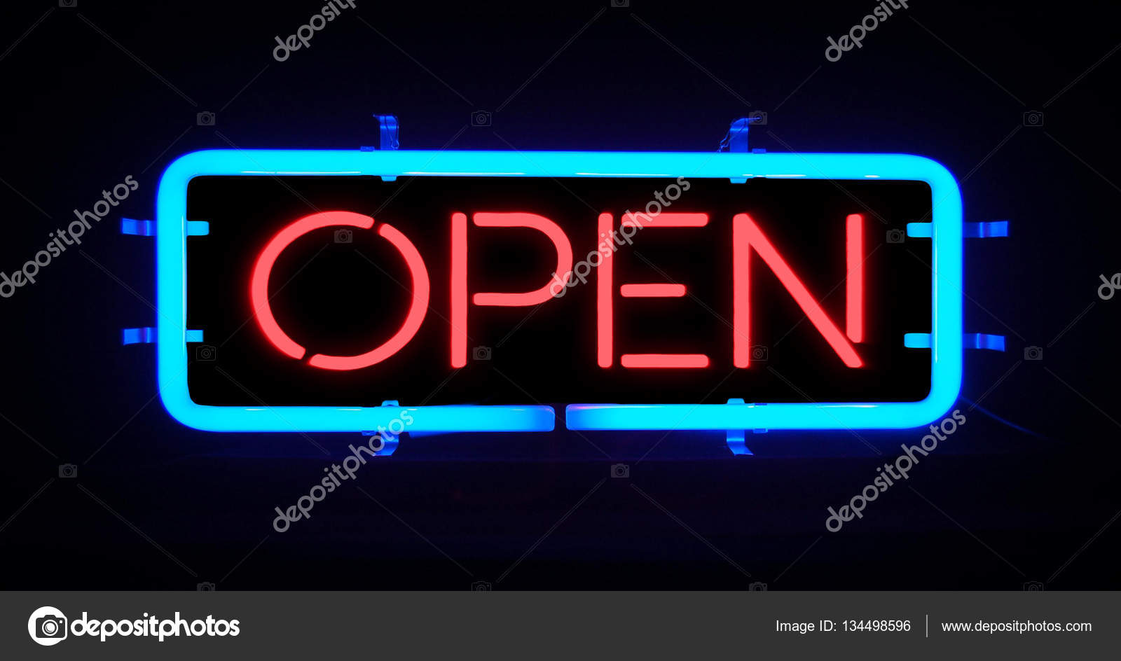 Flickering blinking red and blue neon sign on black background, open ...