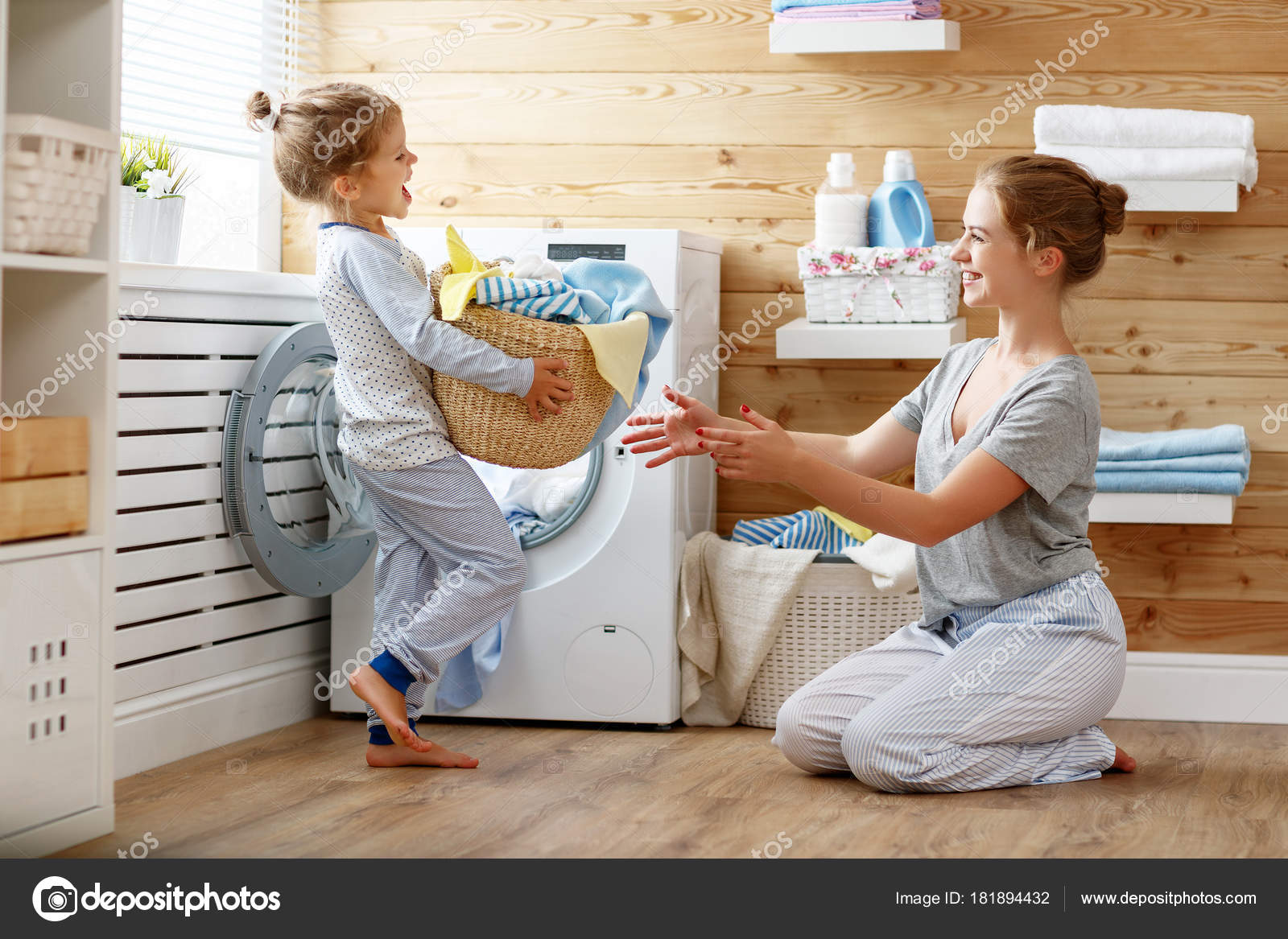 Happy family mother housewife and child in laundry with washin — Stock Photo © evgenyataman ...