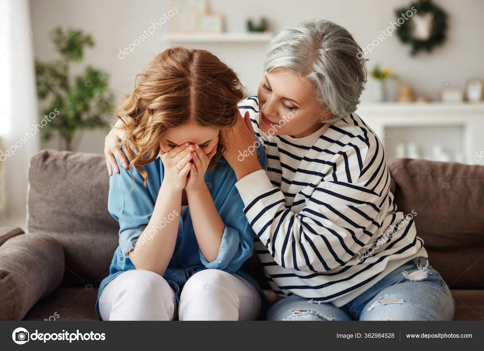 Elderly Woman Embracing Supporting Crying Young Daughter While Sitting ...