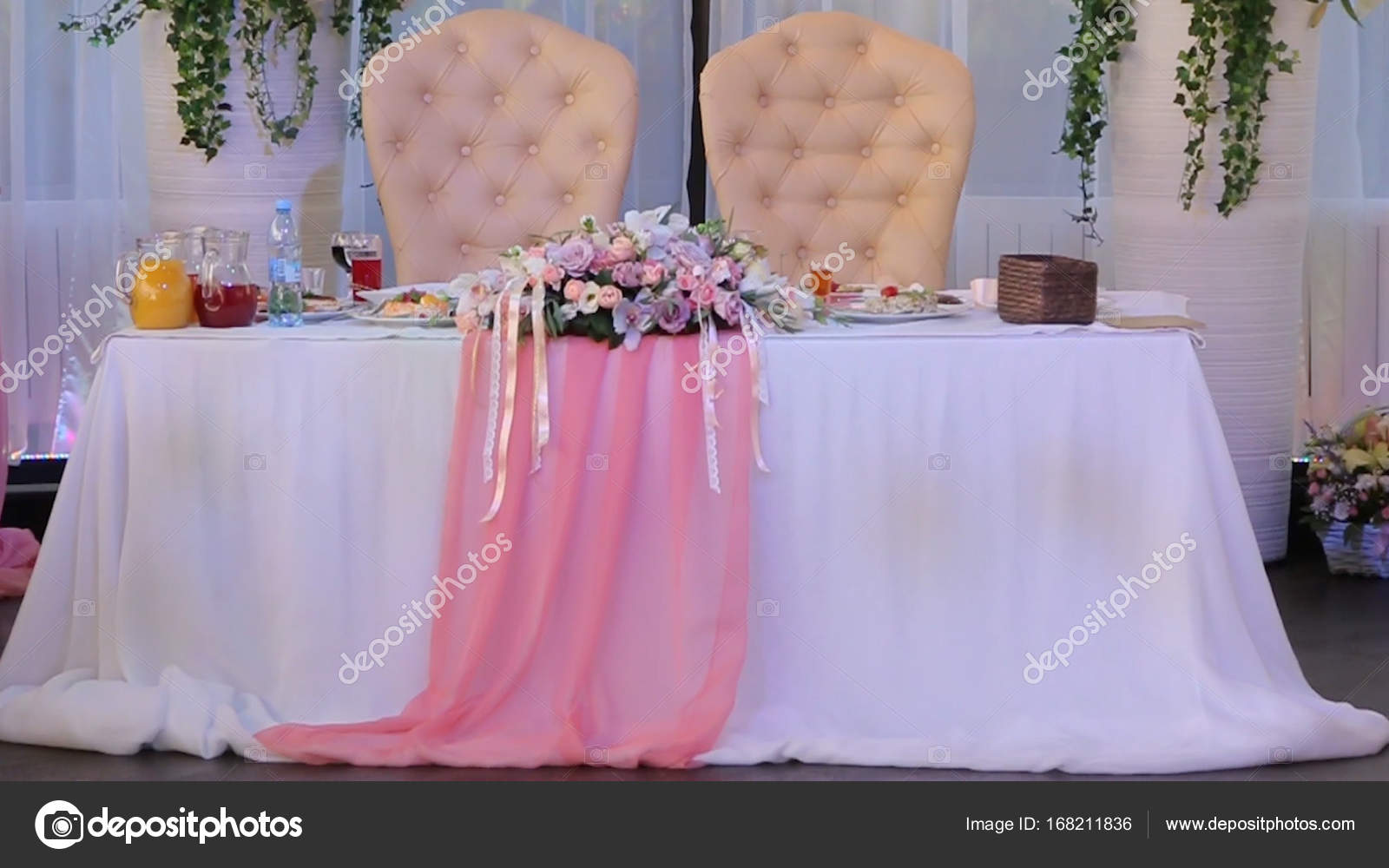 Wedding table at a wedding feast decorated with bridal bouquet. Banquet ...