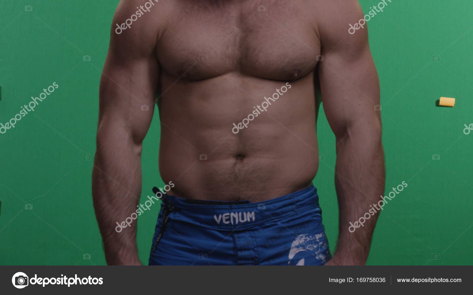Muscular man standing on green screen — Stock Editorial Photo ...