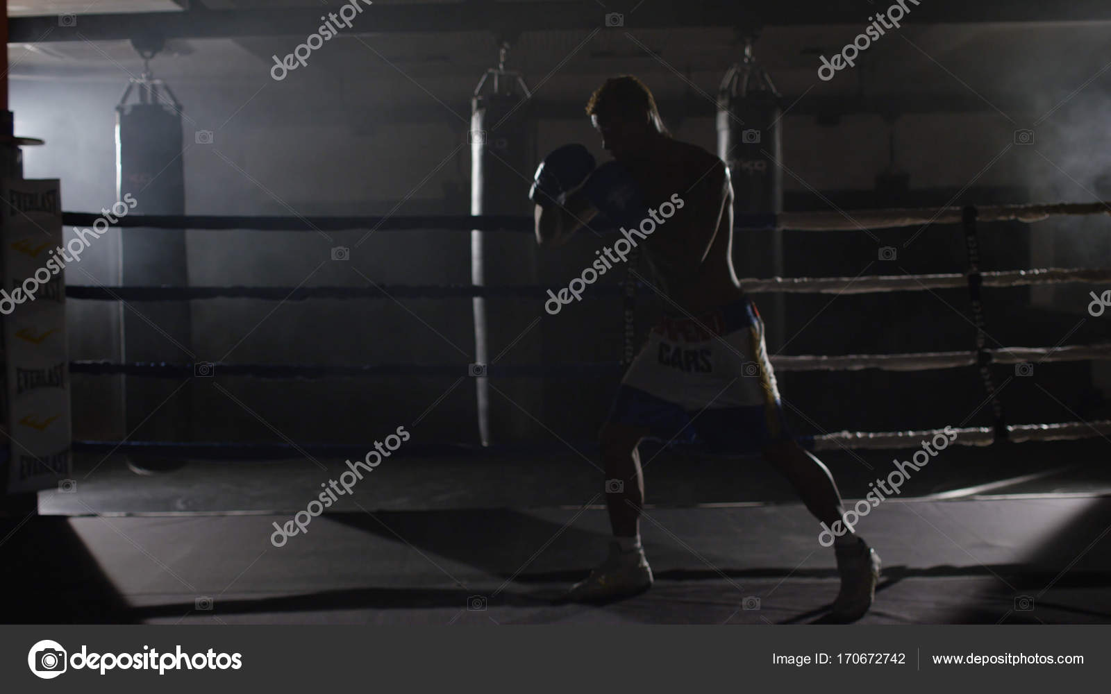 Fighter shadowboxing on training ring. Professional fighter. Male boxer ...