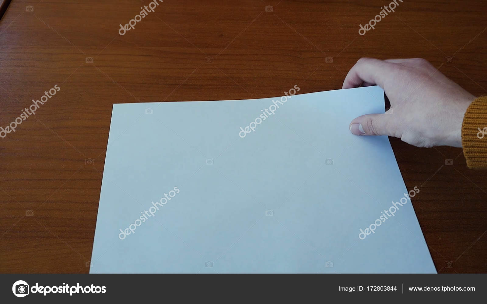 The young man puts on the table a white sheet of paper. Getting started ...