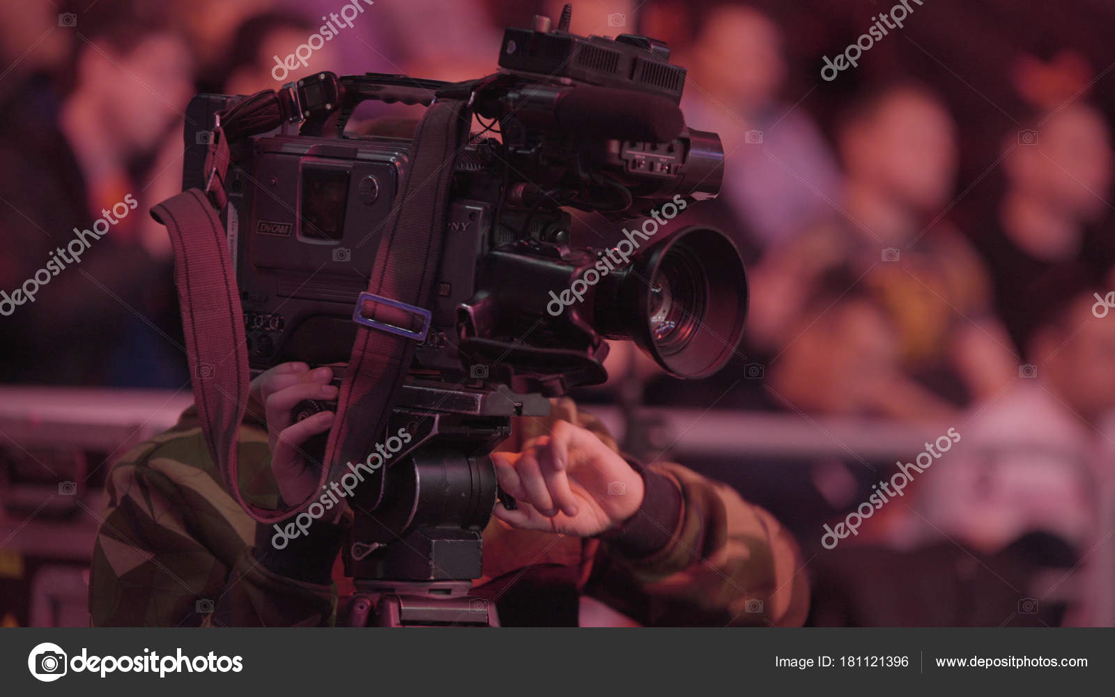 Cameraman using black professional digital video camera. Setup and ...
