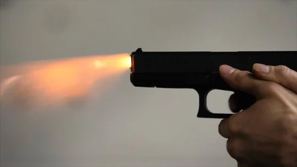 Gun is shot close-up. Pistol in hand close-up. Pistol being shot 1 ...