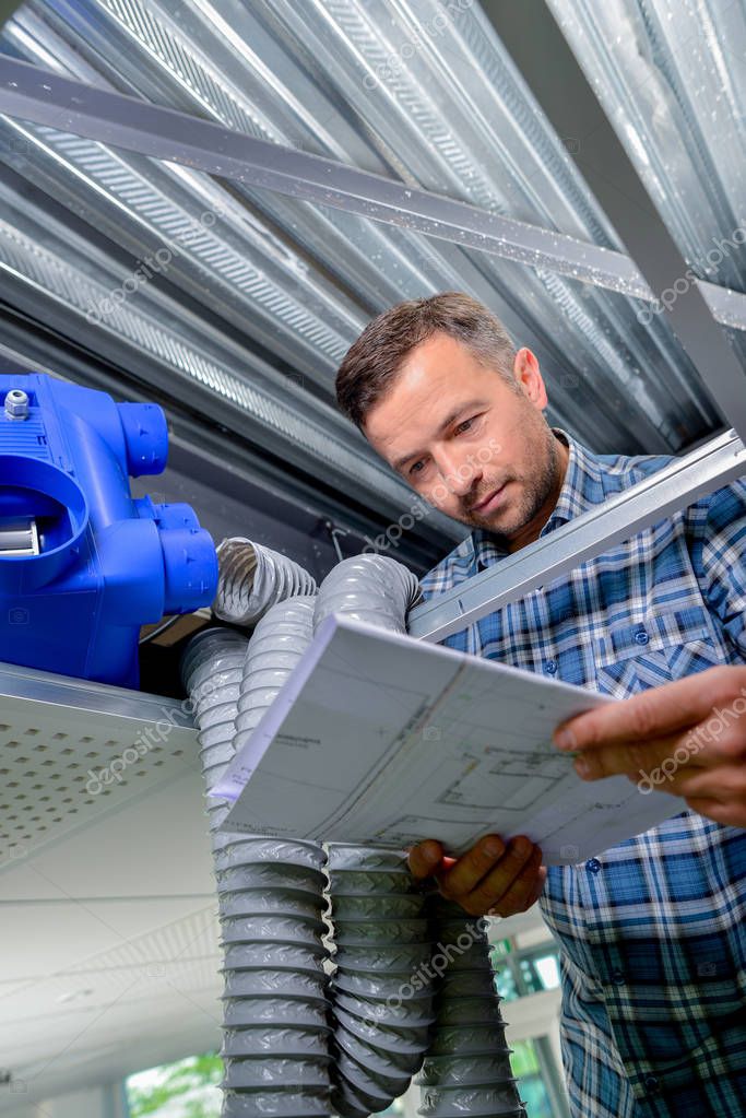 Builder looking at installation instructions Stock Photo by ...