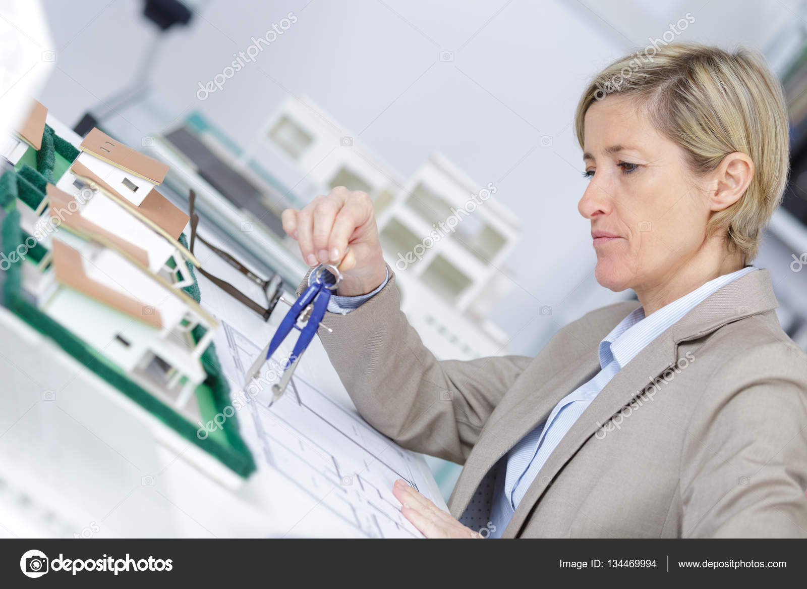 Woman presenting construction model Stock Photo by ©photography33 134469994