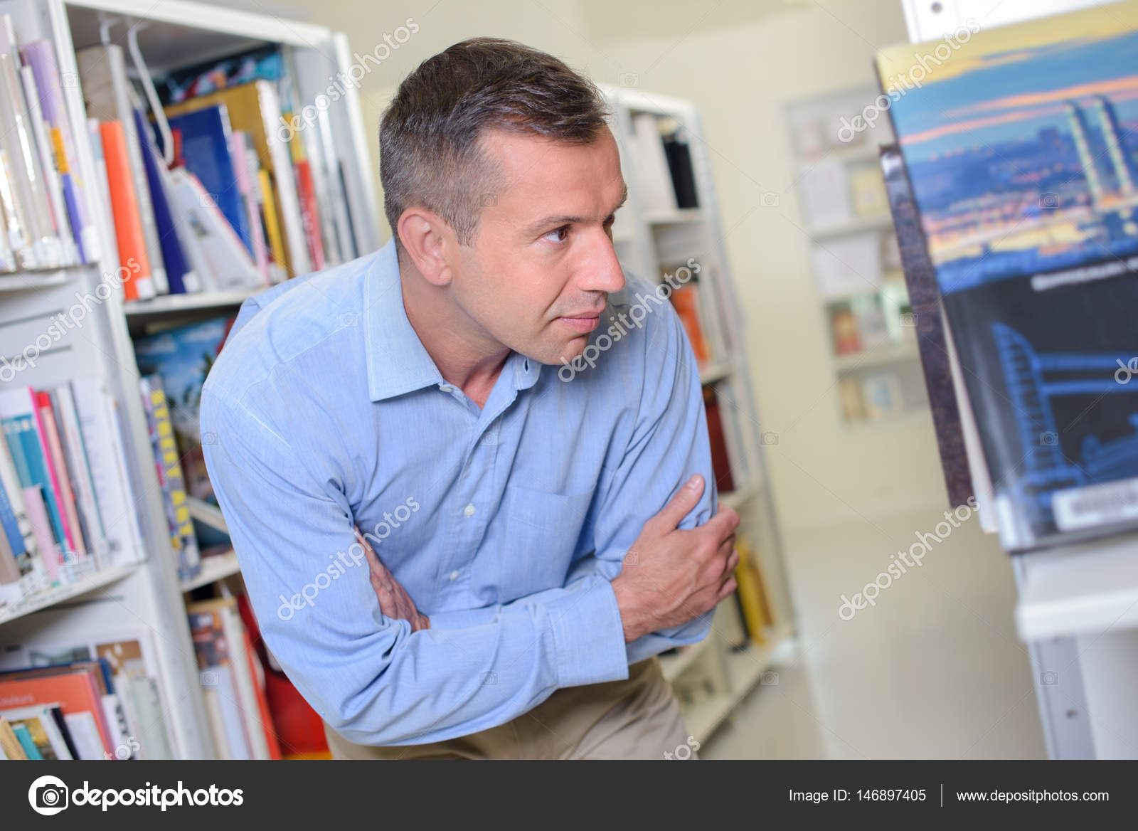Man searching for a specific book Stock Photo by ©photography33 146897405