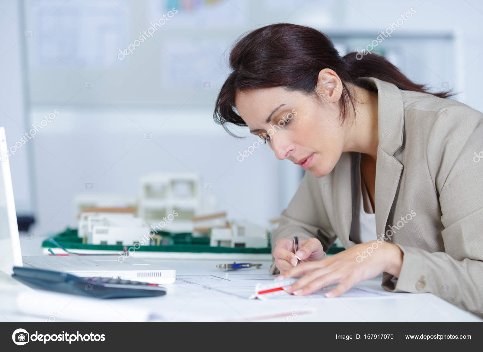 Female architect using scale ruler Stock Photo by ©photography33 157917070