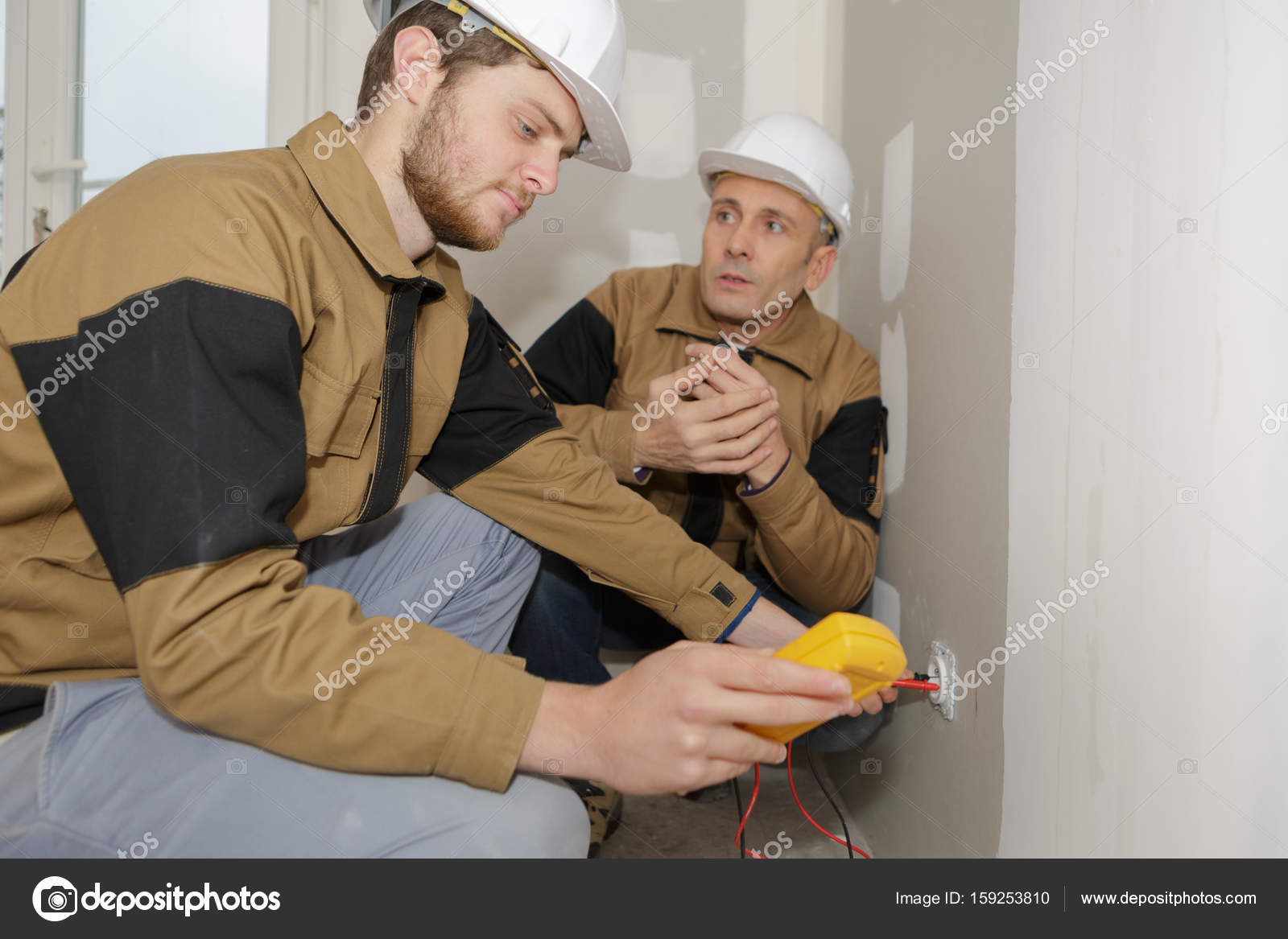 Technician metering socket voltage with digital multimeter — Stock ...