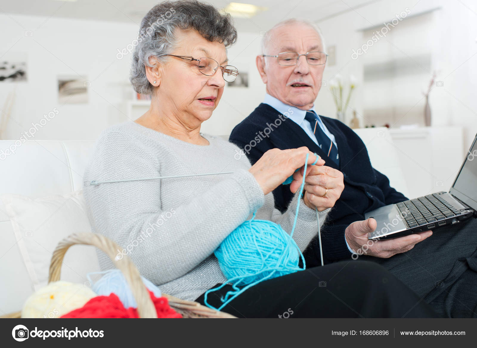 Old man with computer and wife knitting sitting on sofa Stock Photo by ...