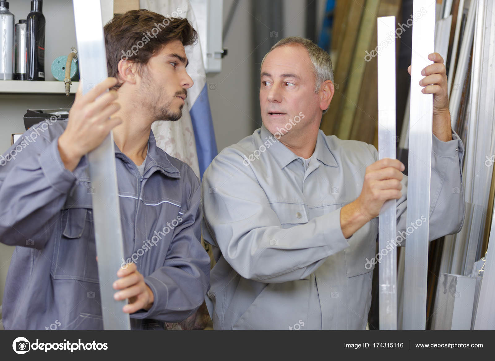 Construction workers lifting reinforcement rods at a factory Stock ...