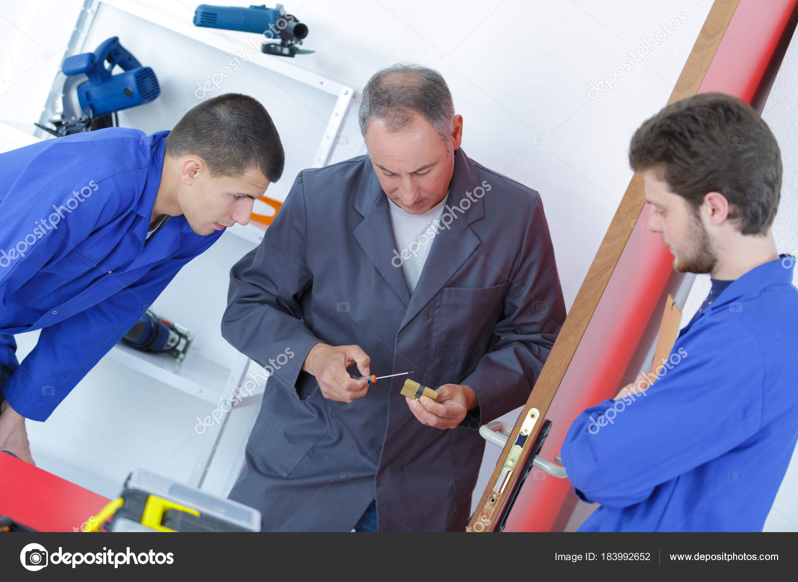 Male carpenter fixing lock in door — Stock Photo © photography33 #183992652