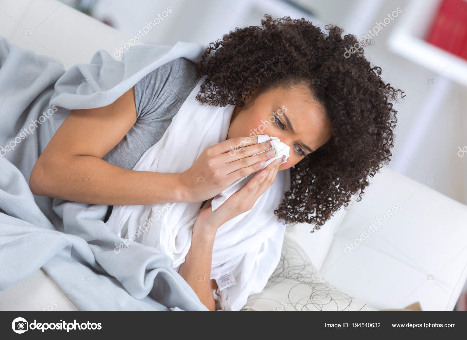 Frustrated sick woman lying on sofa Stock Photo by ©photography33 194540632