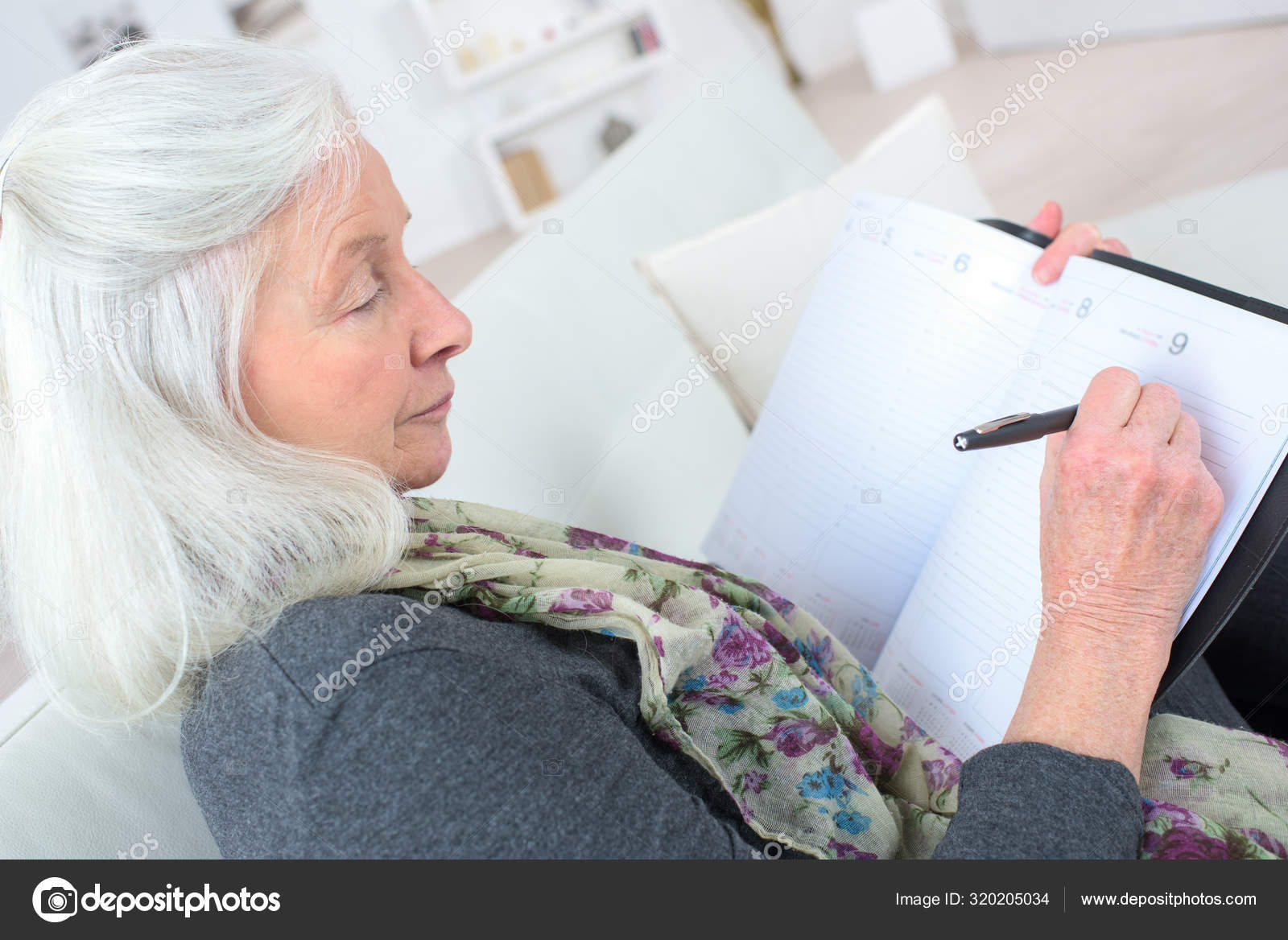 Grey-haired lady taking notes with pencil — Stock Photo © photography33 ...