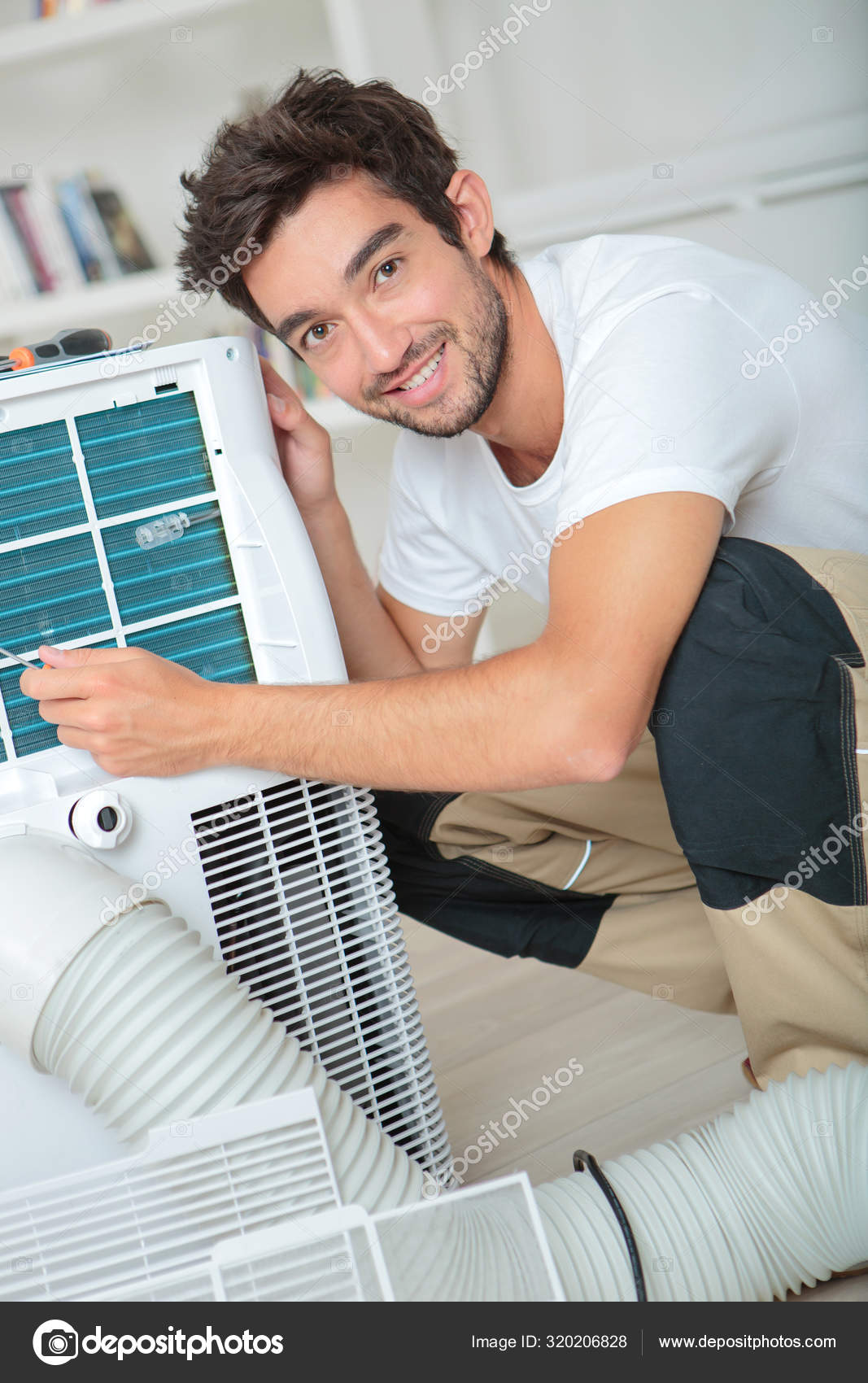 Portrait of man installing air conditioning Stock Photo by ...