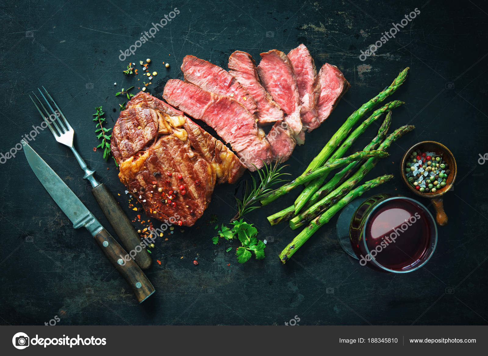 Roasted rib eye steak with green asparagus and wine Stock Photo by ...
