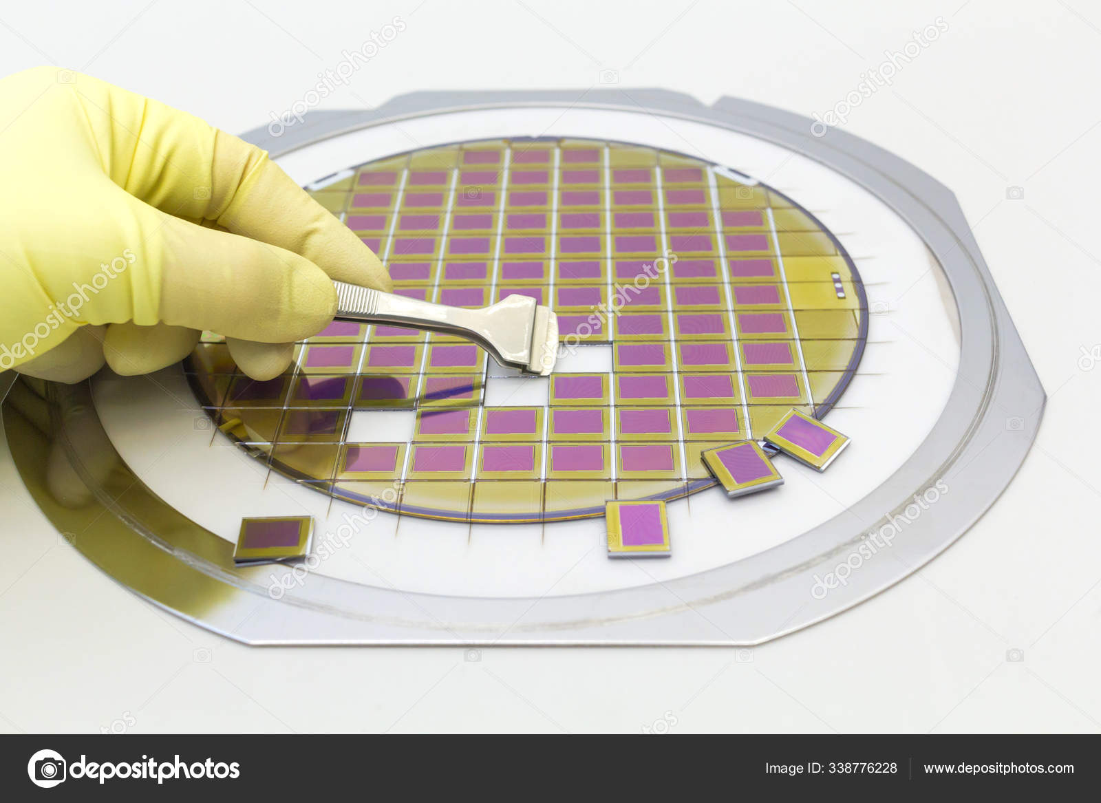 Silicon wafer with microchips, fixed in a holder with a steel frame on ... Silicon wafer with microchips, fixed in a holder with a steel frame on ...