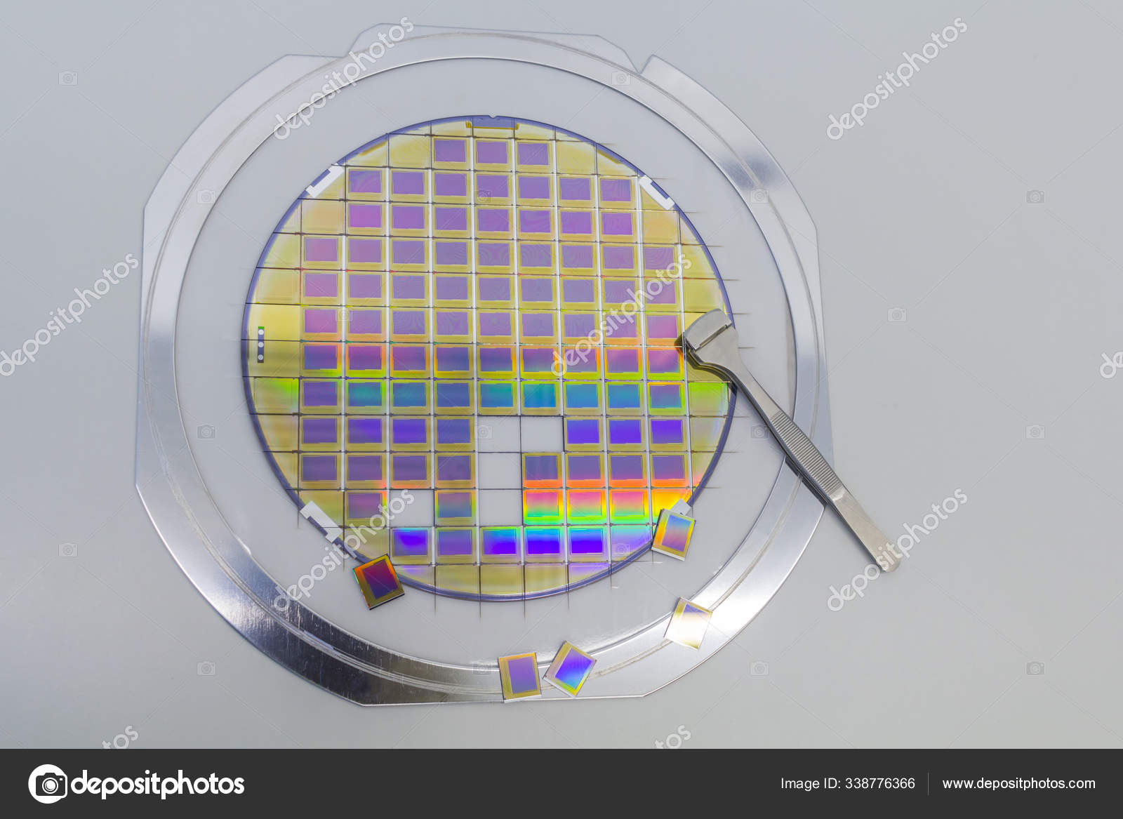 Silicon wafer with microchips, fixed in a holder with a steel frame on ... Silicon wafer with microchips, fixed in a holder with a steel frame on ...