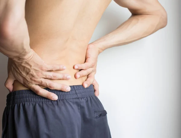 Man touching his back because of severe back pain - Stock Image ...